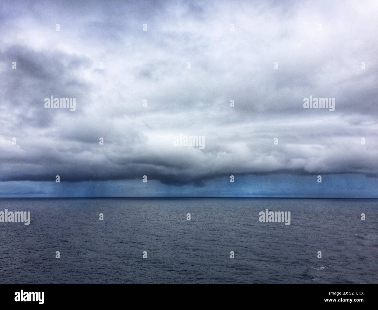 Rain falling in the distance on the open ocean Stock Photo - Alamy