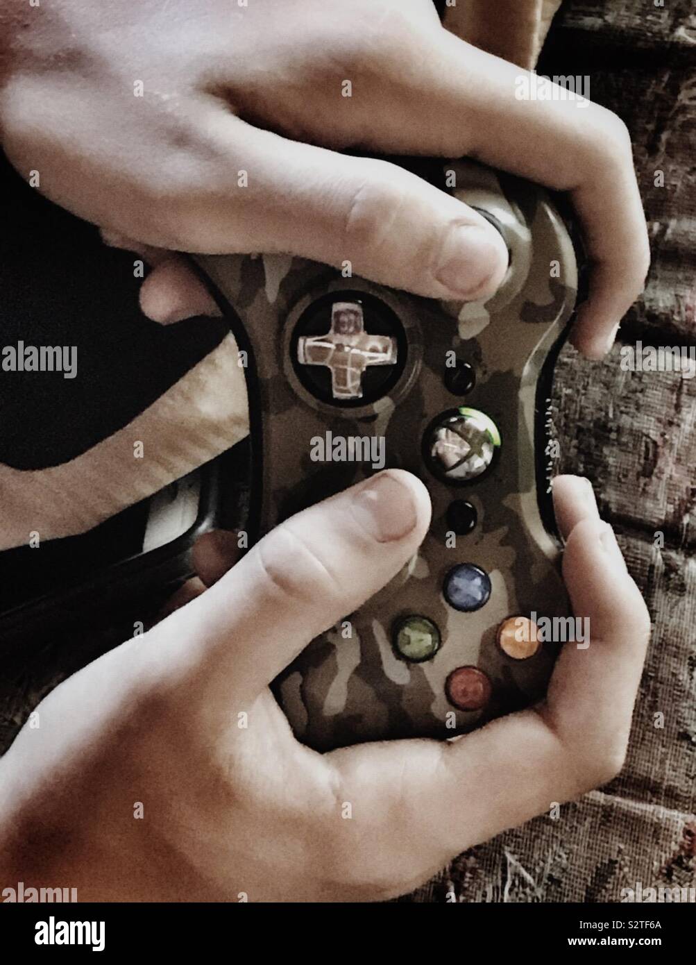 Male hands holding a video game remote Stock Photo - Alamy