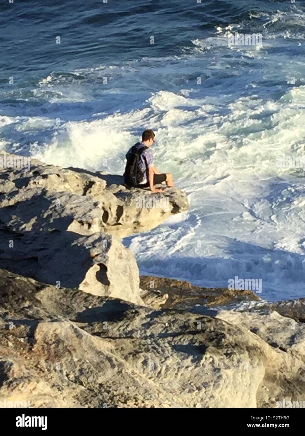 Man Sitting On A Cliff High Resolution Stock Photography and Images - Alamy