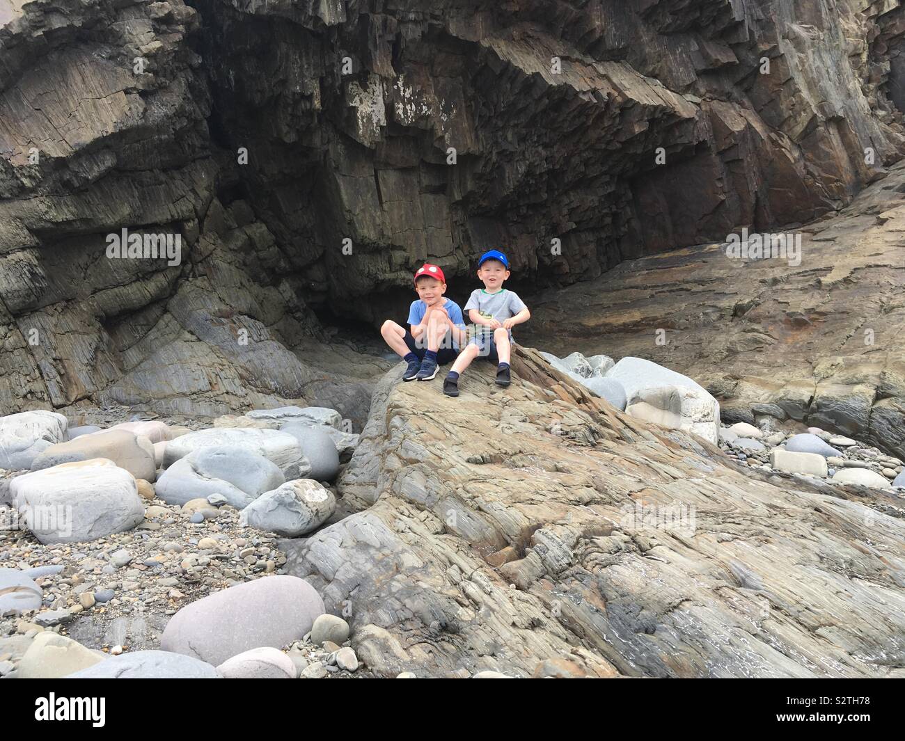 Cliff side cave Stock Photo - Alamy