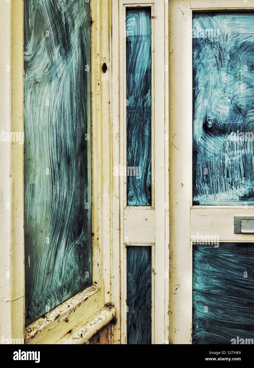 Dirty doorway with whitewashed glass panels Stock Photo - Alamy