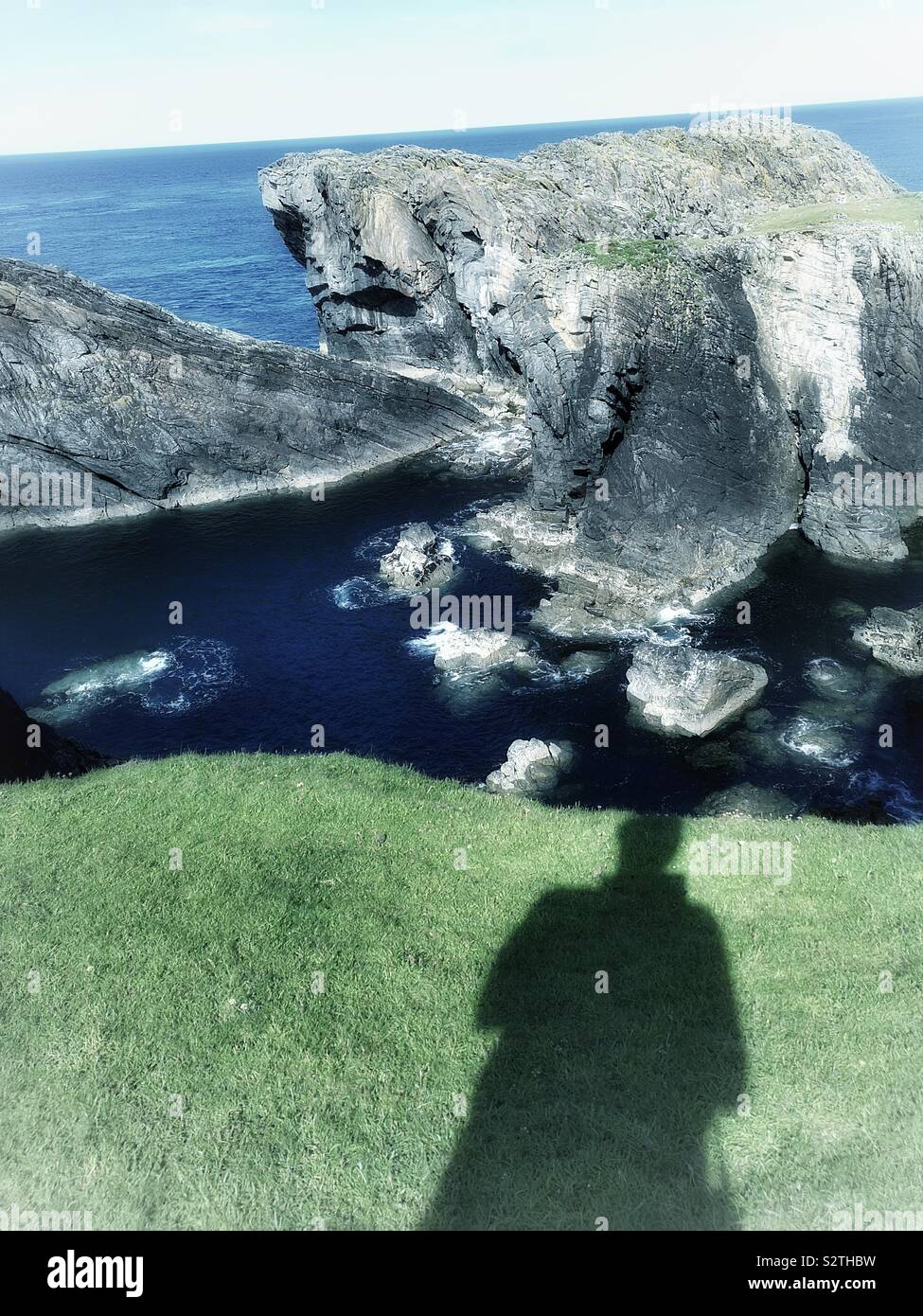 Shadow of person standing at top of dramatic cliffs, Butt of Lewis ...