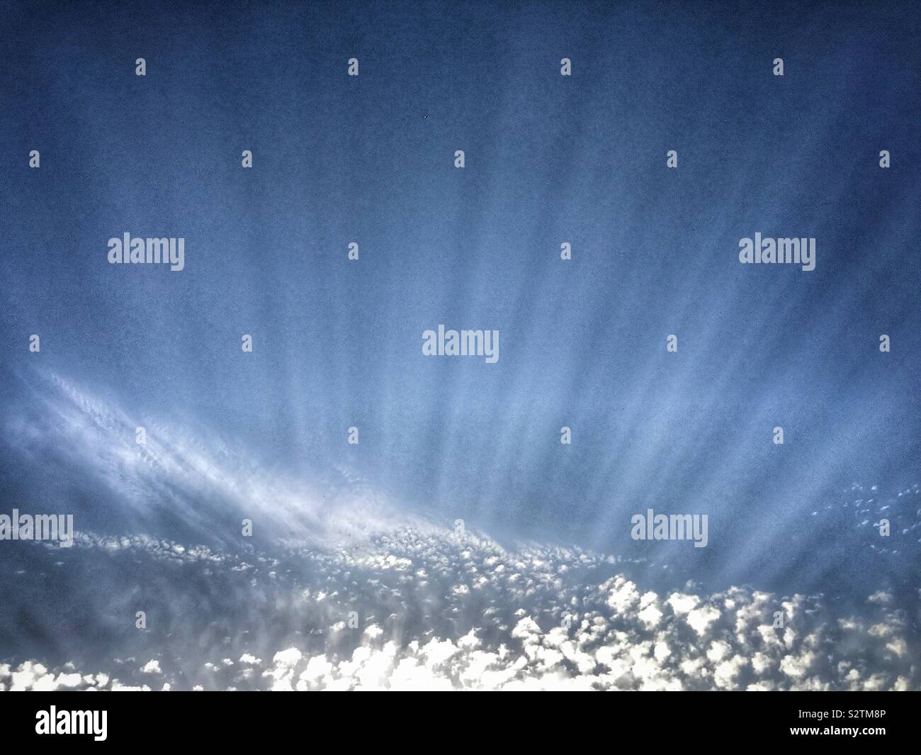 Sun streaks reflected off high clouds Stock Photo - Alamy