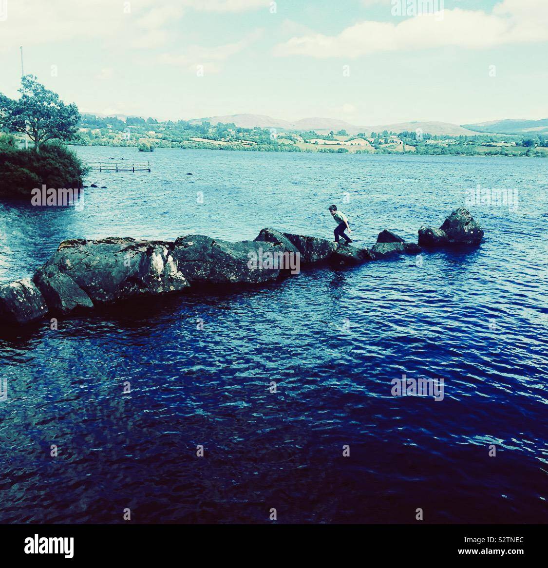 Child playing at lake in Donegal Ireland Stock Photo - Alamy