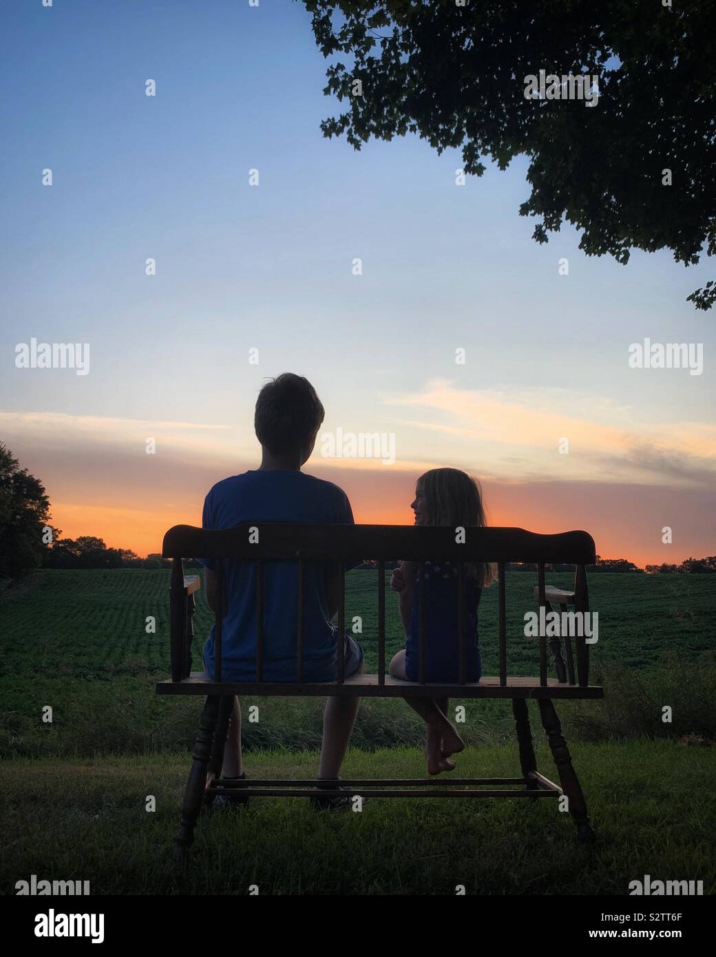 Sitting together watching the sunset Stock Photo - Alamy