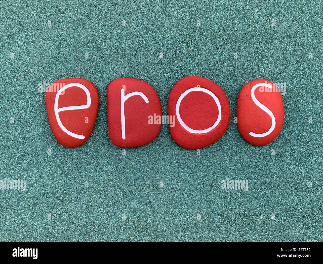 Eros, male given name composed with red colored stone letters over ...