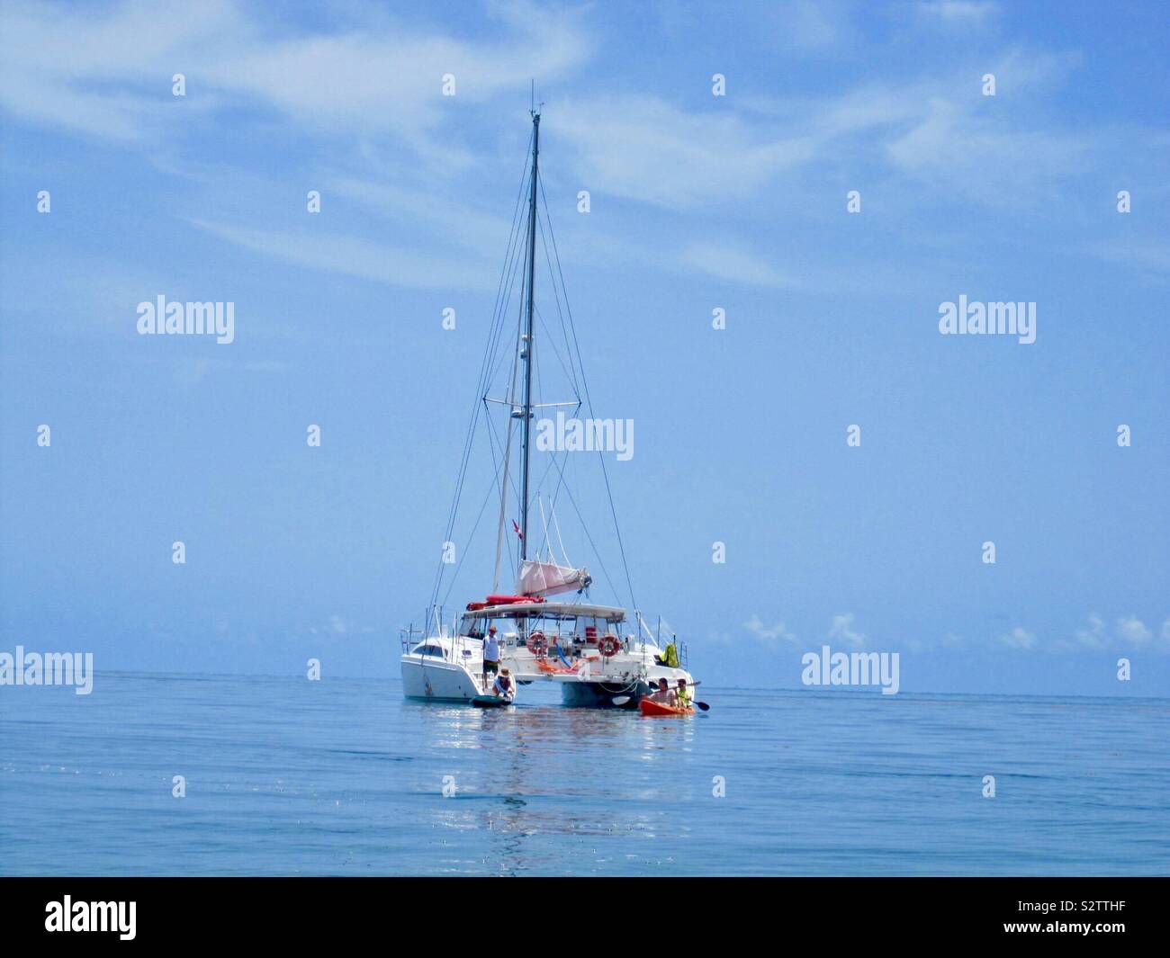 Catamaran and kayak at sea Stock Photo - Alamy