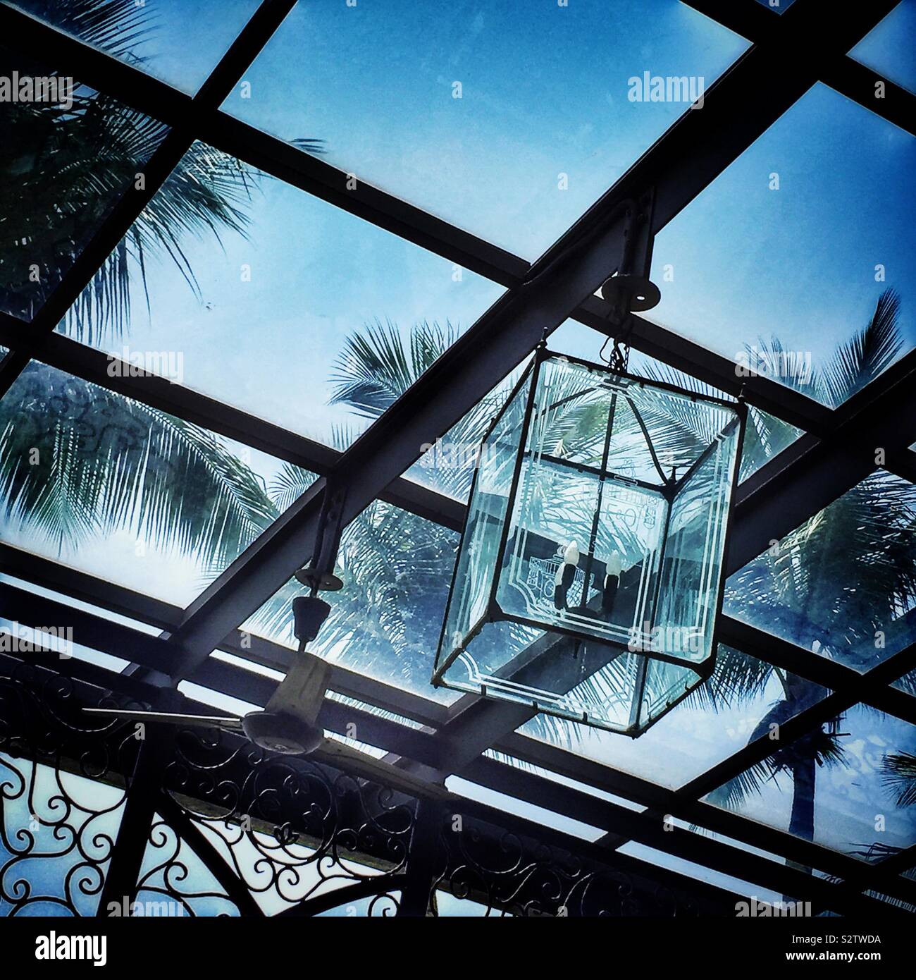 Detail of the glass roof and a lamp in the outdoor area of Sarkies ...