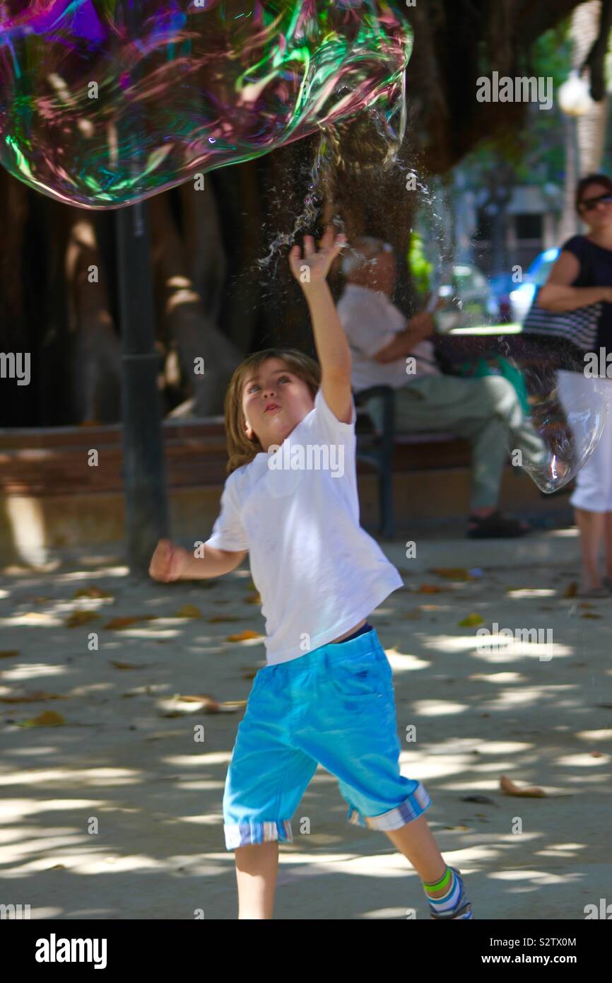 Boy bursting bubbles hi-res stock photography and images - Alamy