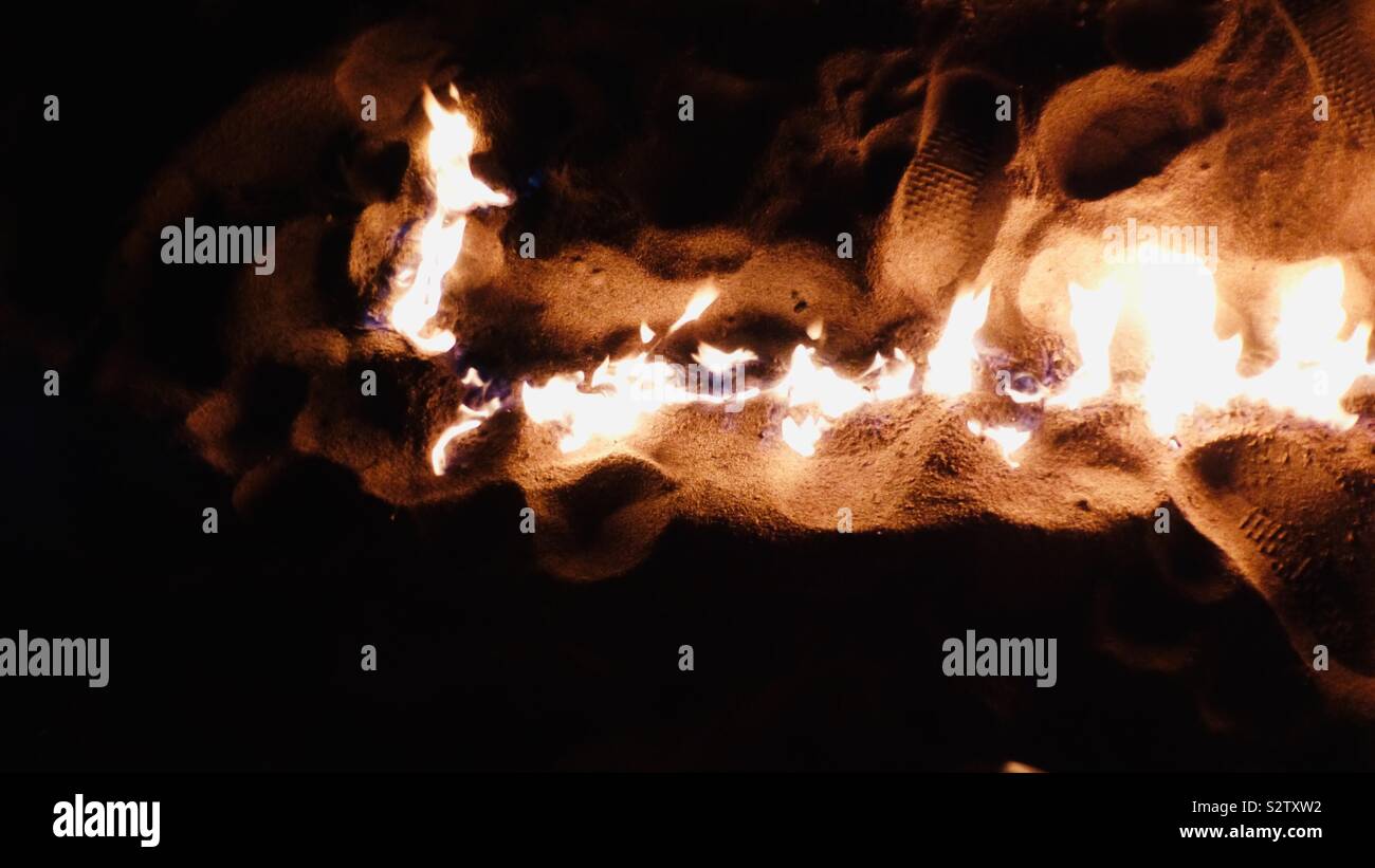 Trail of fire in the sand Stock Photo - Alamy