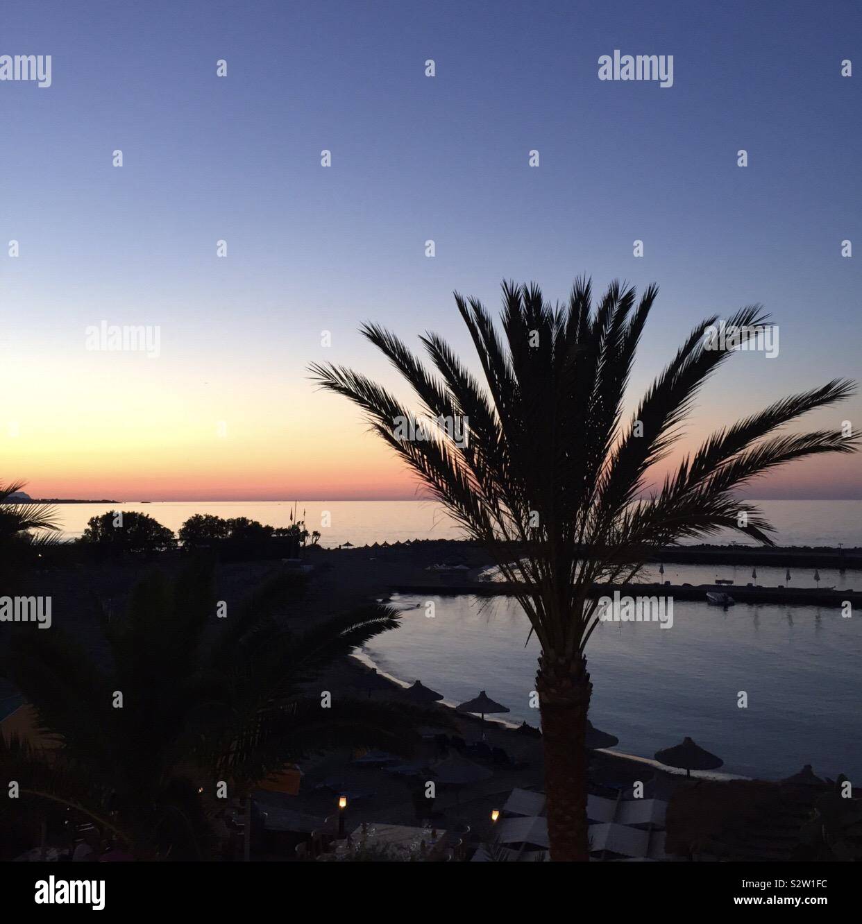 Sunset over the sea.. beach life Stock Photo - Alamy