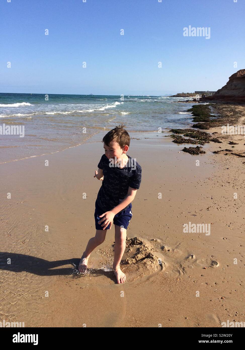 Kid playing on beach in Spain Stock Photo - Alamy