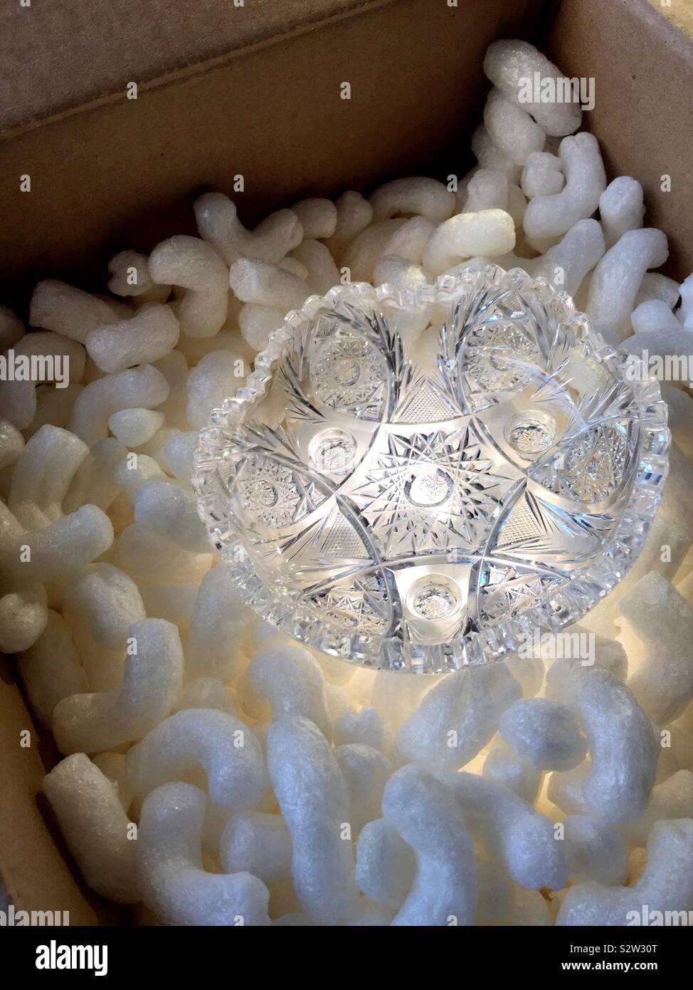 Fragile Cut glass crystal bowl in a cardboard packing box surrounded by ...