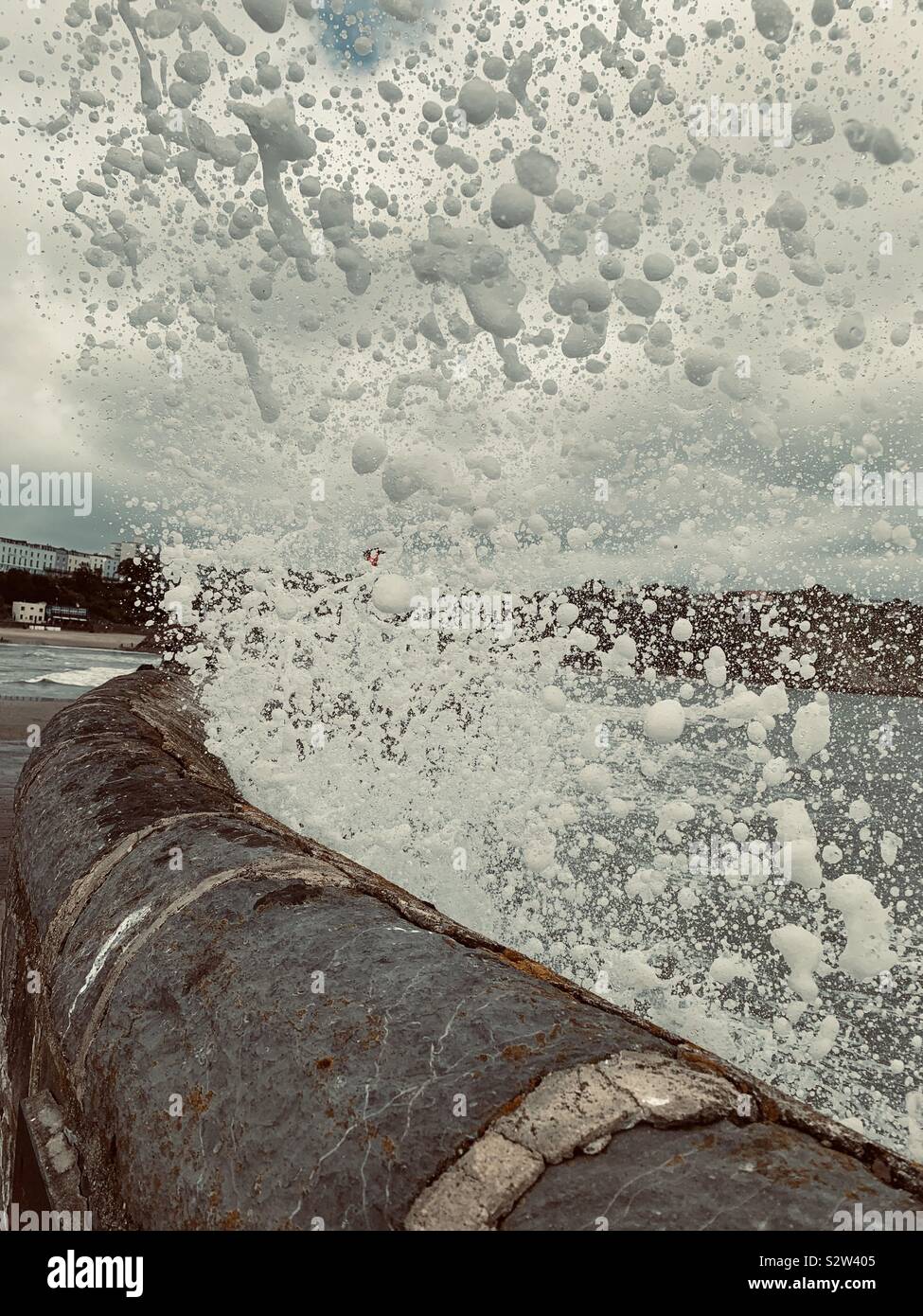 Wave going over wall Stock Photo - Alamy