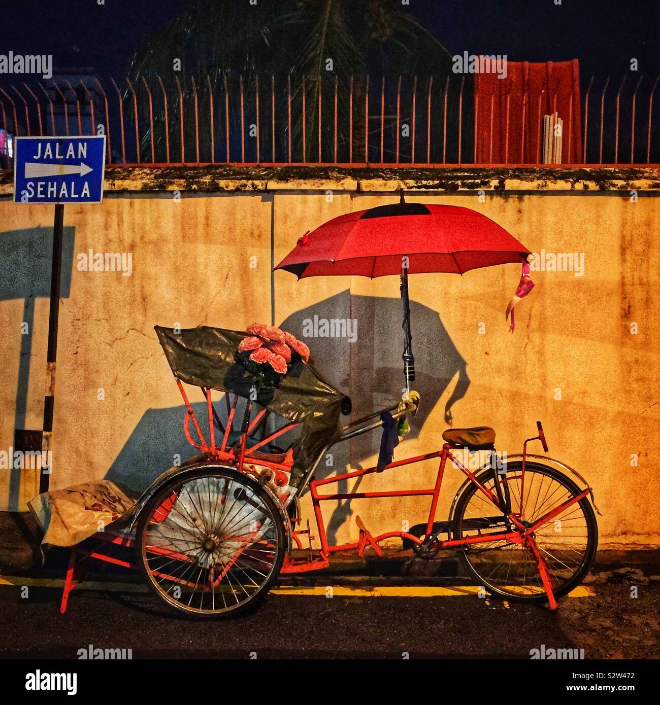 A trishaw, known locally as a 'beca', parked at night in the Old Town ...