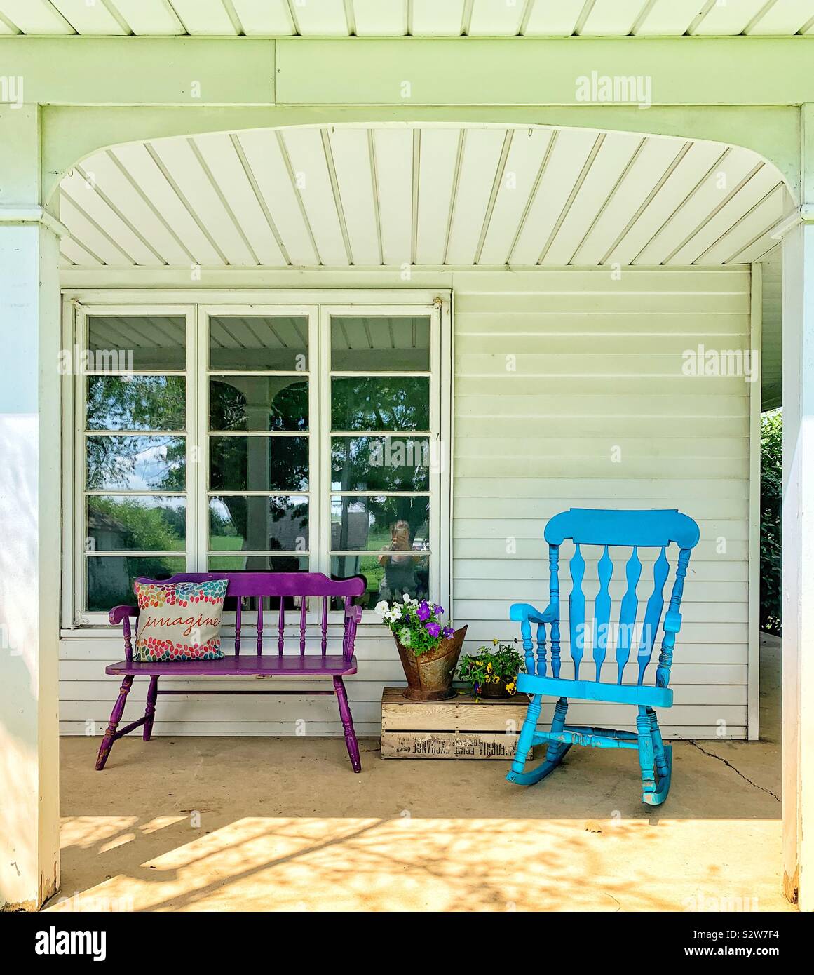 Outdoor porch with colorful chairs Stock Photo - Alamy