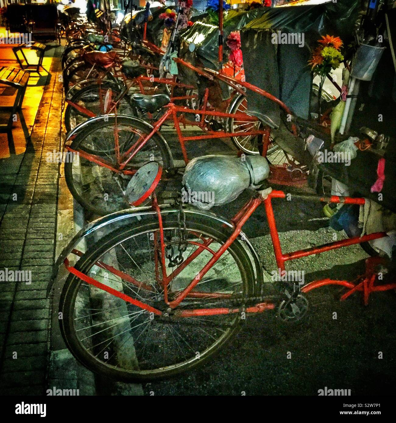 Trishaws, known locally as 'becas', parked at night in the Old Town of ...