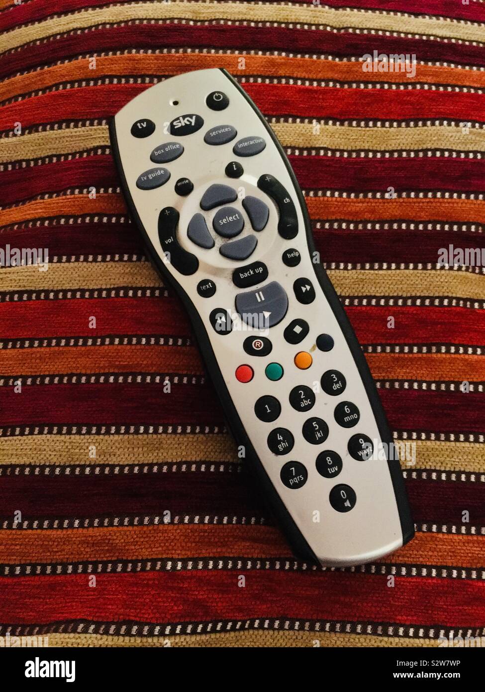 Remote control on a autumn coloured cushion Stock Photo - Alamy