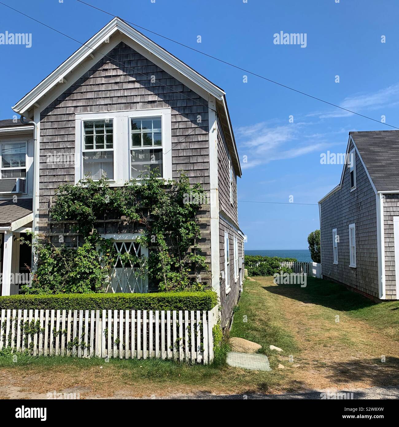 A path towards the ocean between homes in the town of Siasconset ...