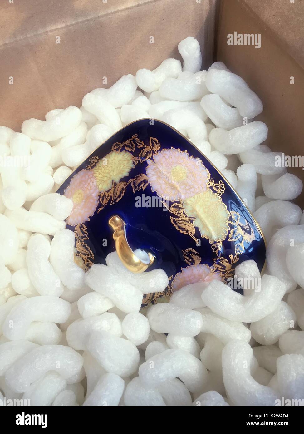 Fragile china serving dish in a cardboard packing box surrounded by ...