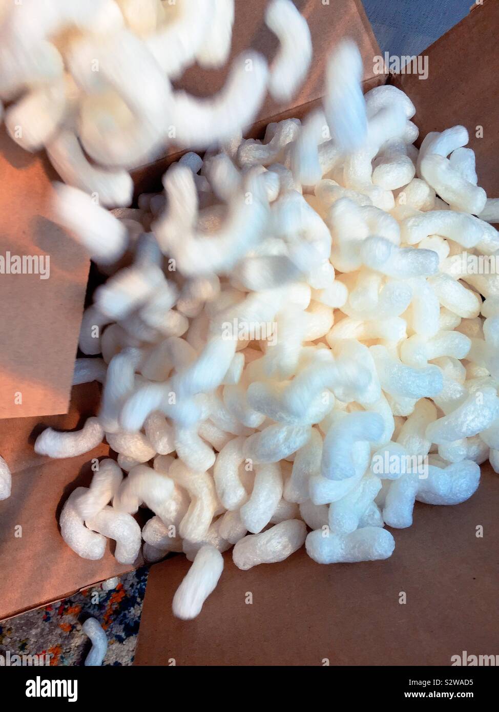 Motion blur of the Styrofoam peanuts stealing a cardboard packing box ...