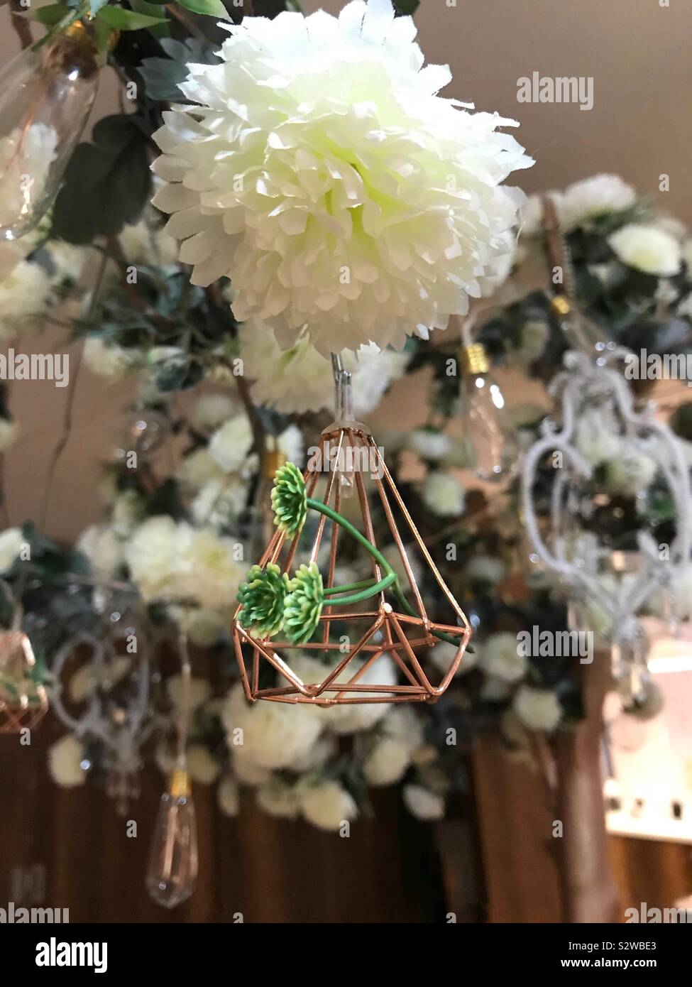 Flower holding a pyramid with a plant, decoration set Stock Photo - Alamy