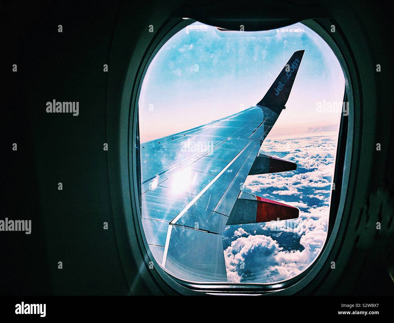 Aeroplane wing view from window whilst flying Stock Photo - Alamy