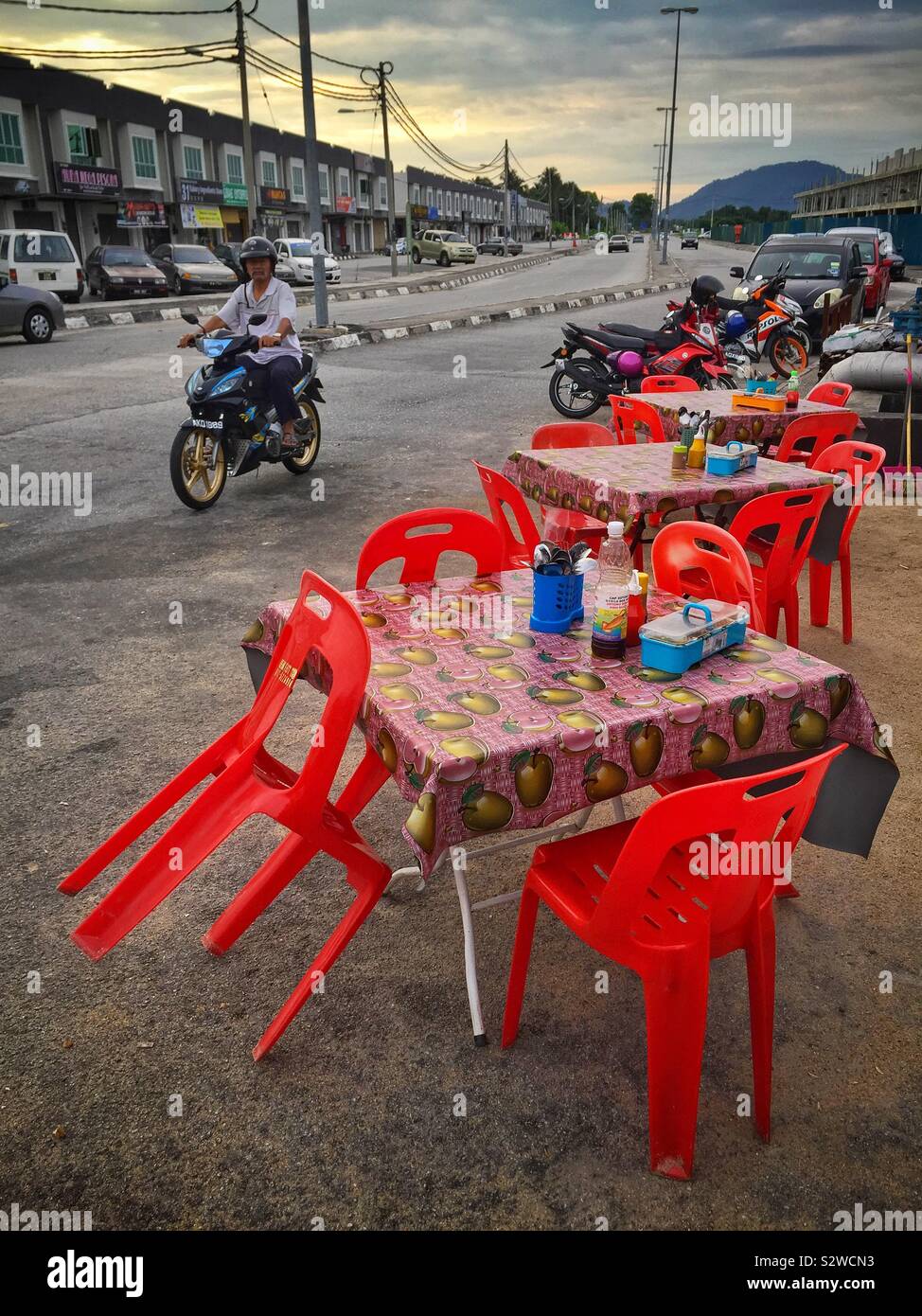 Tables set for dinner at a night street market, Sitiawan, Perak ...