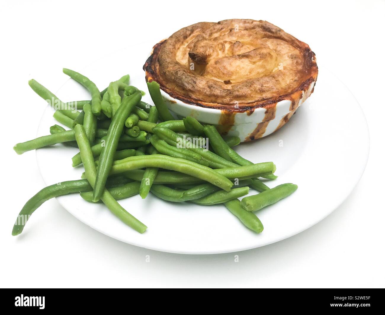 Vegetable cottage pie served with french green beans Stock Photo - Alamy