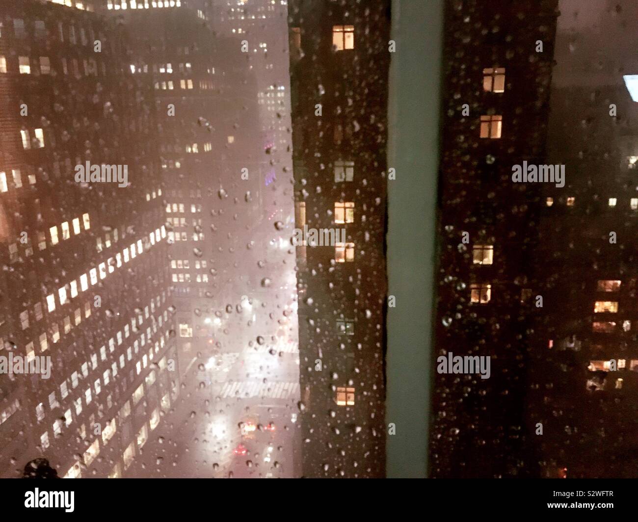 Looking out a apartment casement window in midtown Manhattan during a ...