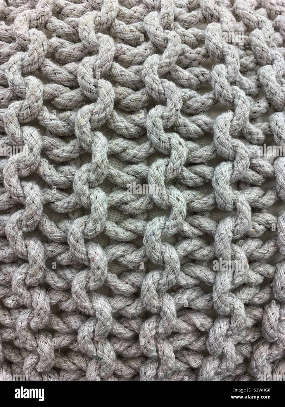 Grey yarn displayed in a beautiful loop macrame pattern Stock Photo - Alamy