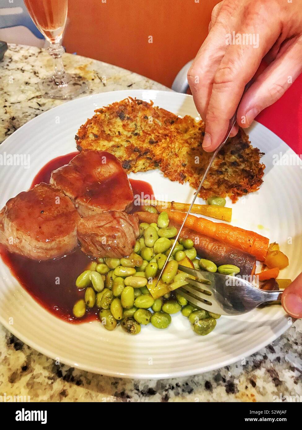Filet medallions with potato rosti, edamame beans and tricolor carrots ...