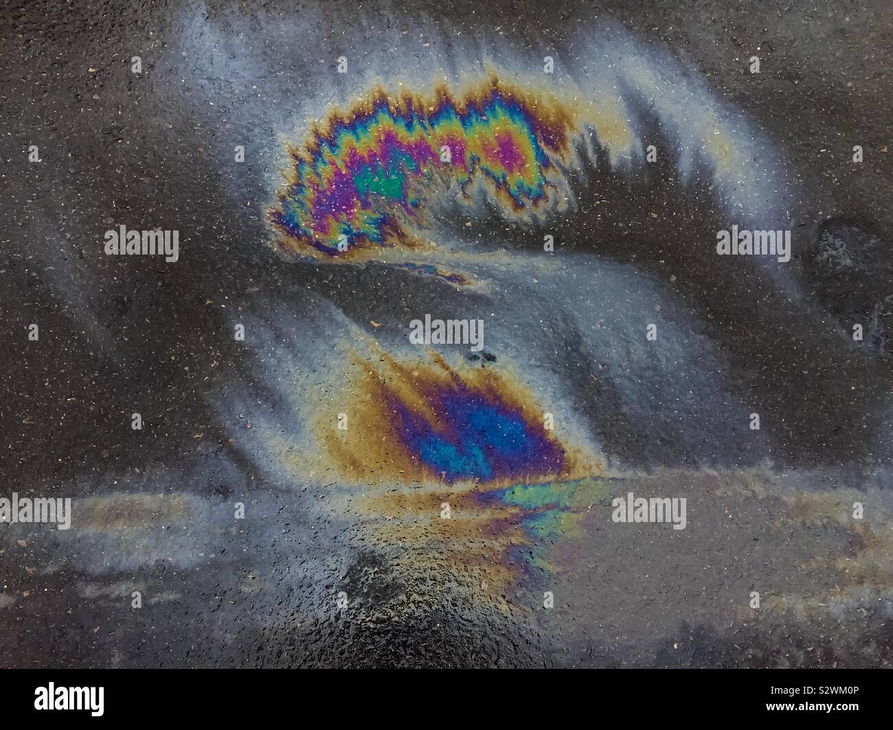 Oil on asphalt and water Stock Photo - Alamy