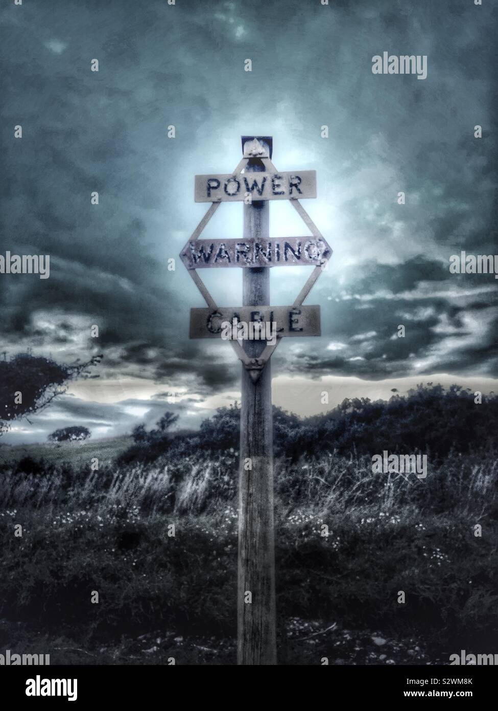 Power cable warning post Stock Photo - Alamy