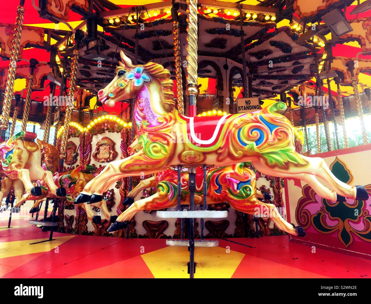 Fairground carousel galloping horse ride Stock Photo - Alamy