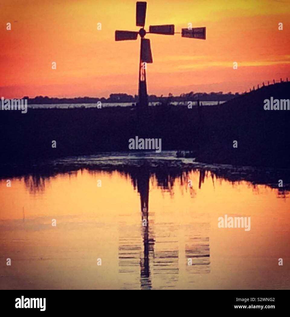 Small windmill gives a beautiful reflection Stock Photo - Alamy