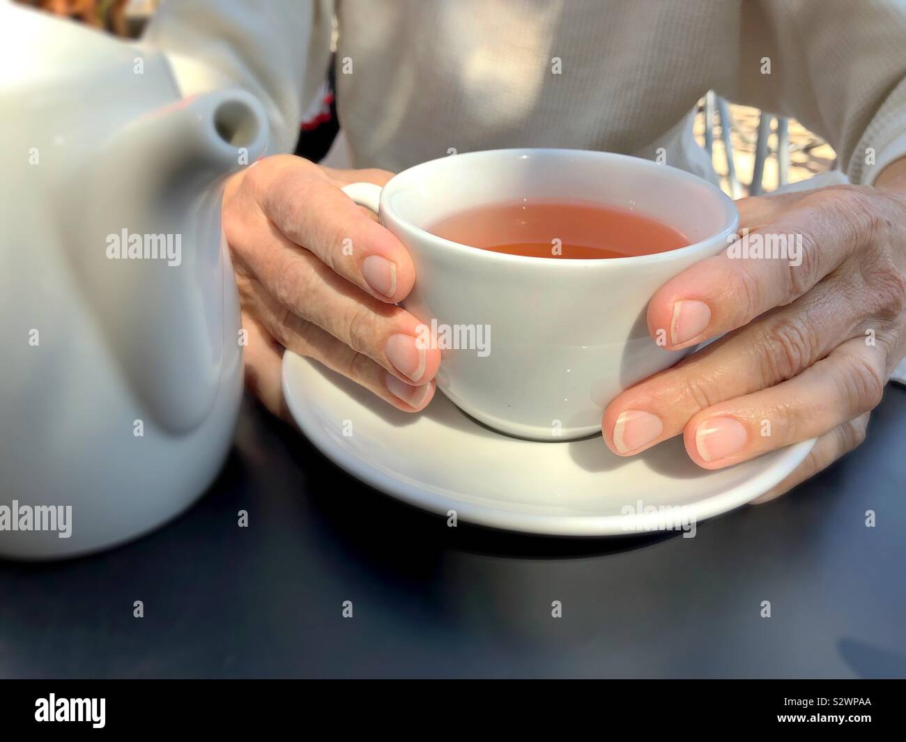 Hands wrapped around cup hi-res stock photography and images - Alamy