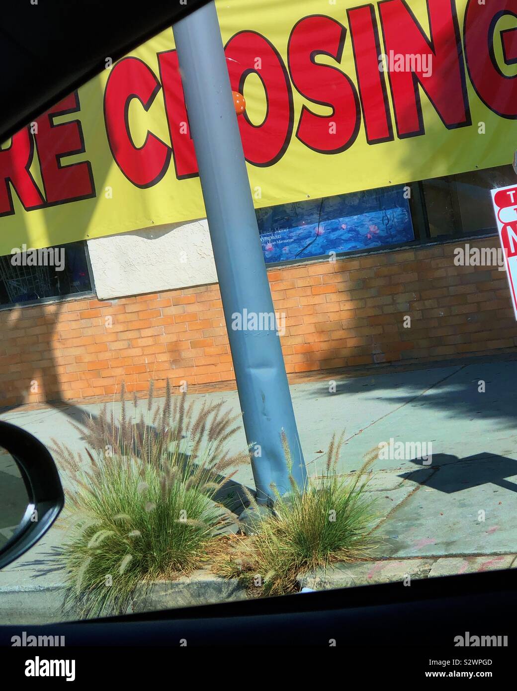 Going out of business. Store closing sign in front window. A sense of ...