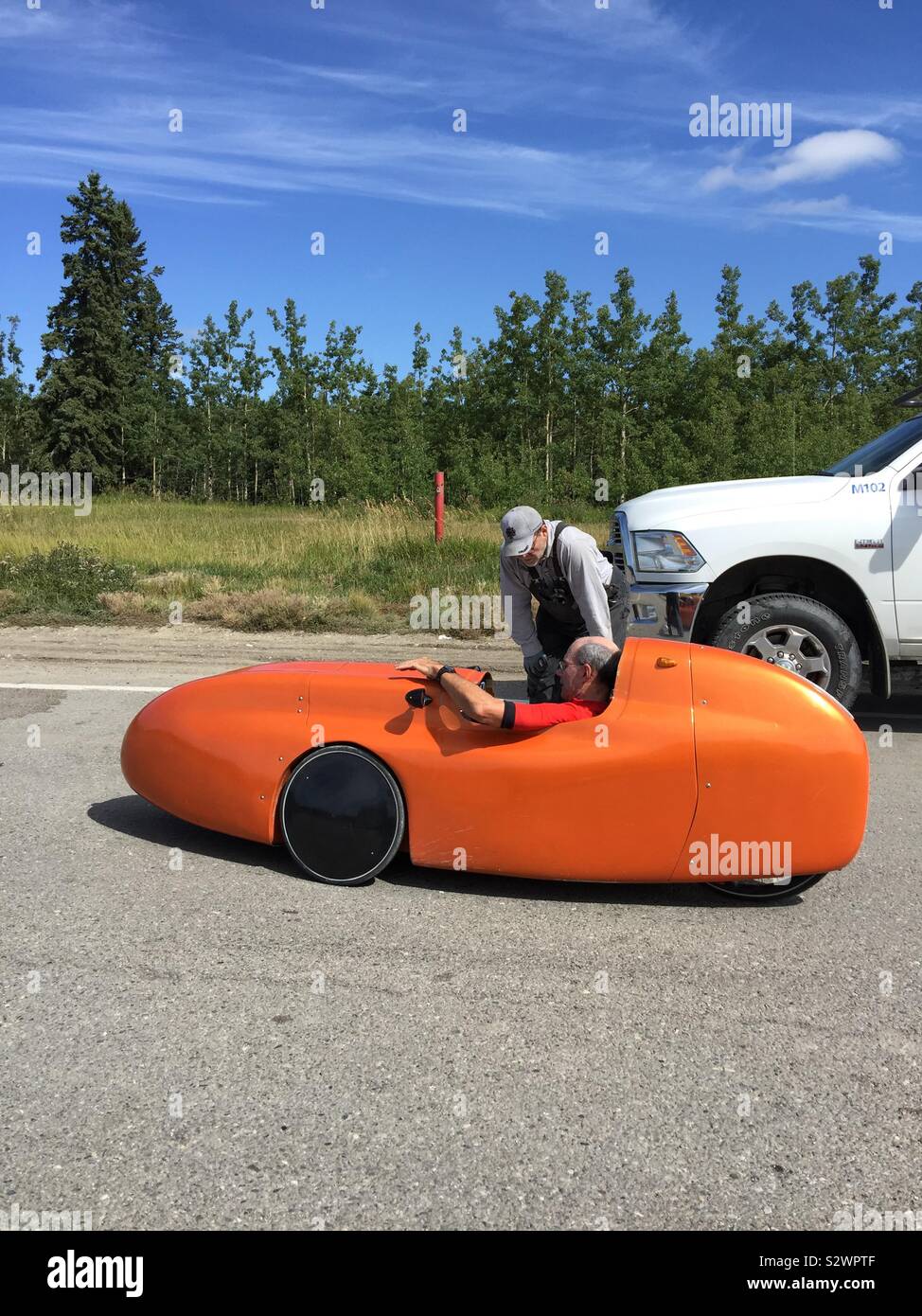 Unique Three wheeler orange vehicle Stock Photo - Alamy