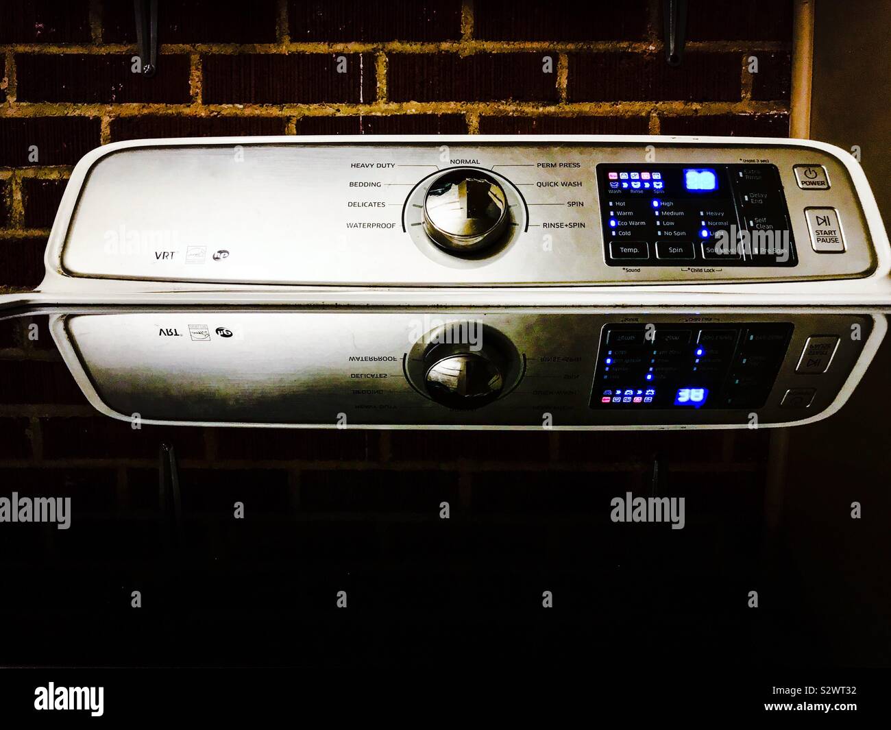 Dark photo of washing machine and reflection Stock Photo - Alamy