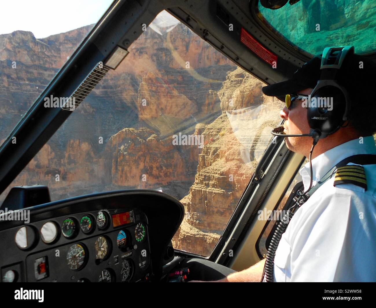 Helicopter pilot flying across the Grand Canyon aerial tour Stock Photo ...