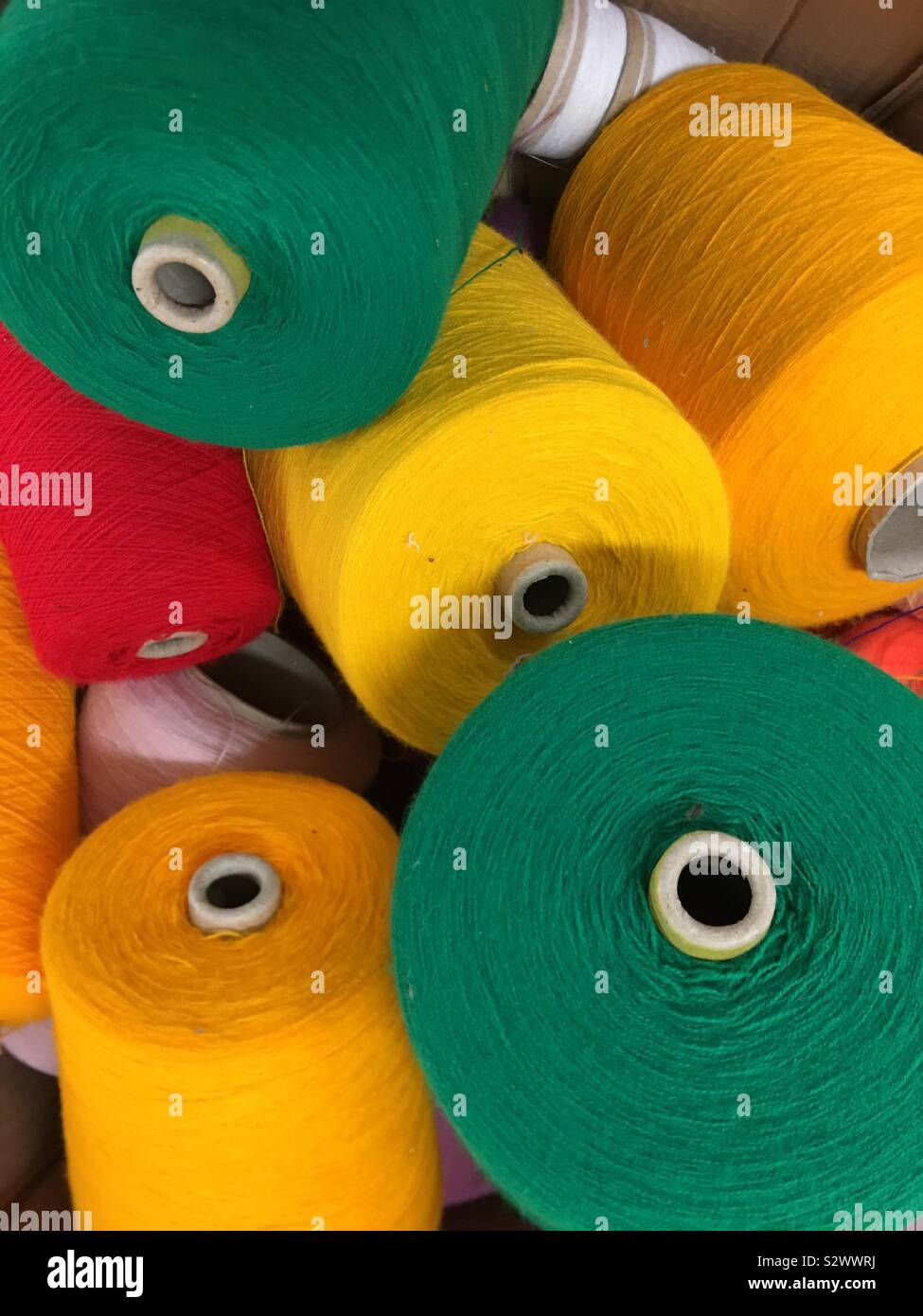 Multi coloured cones of yarn Stock Photo - Alamy