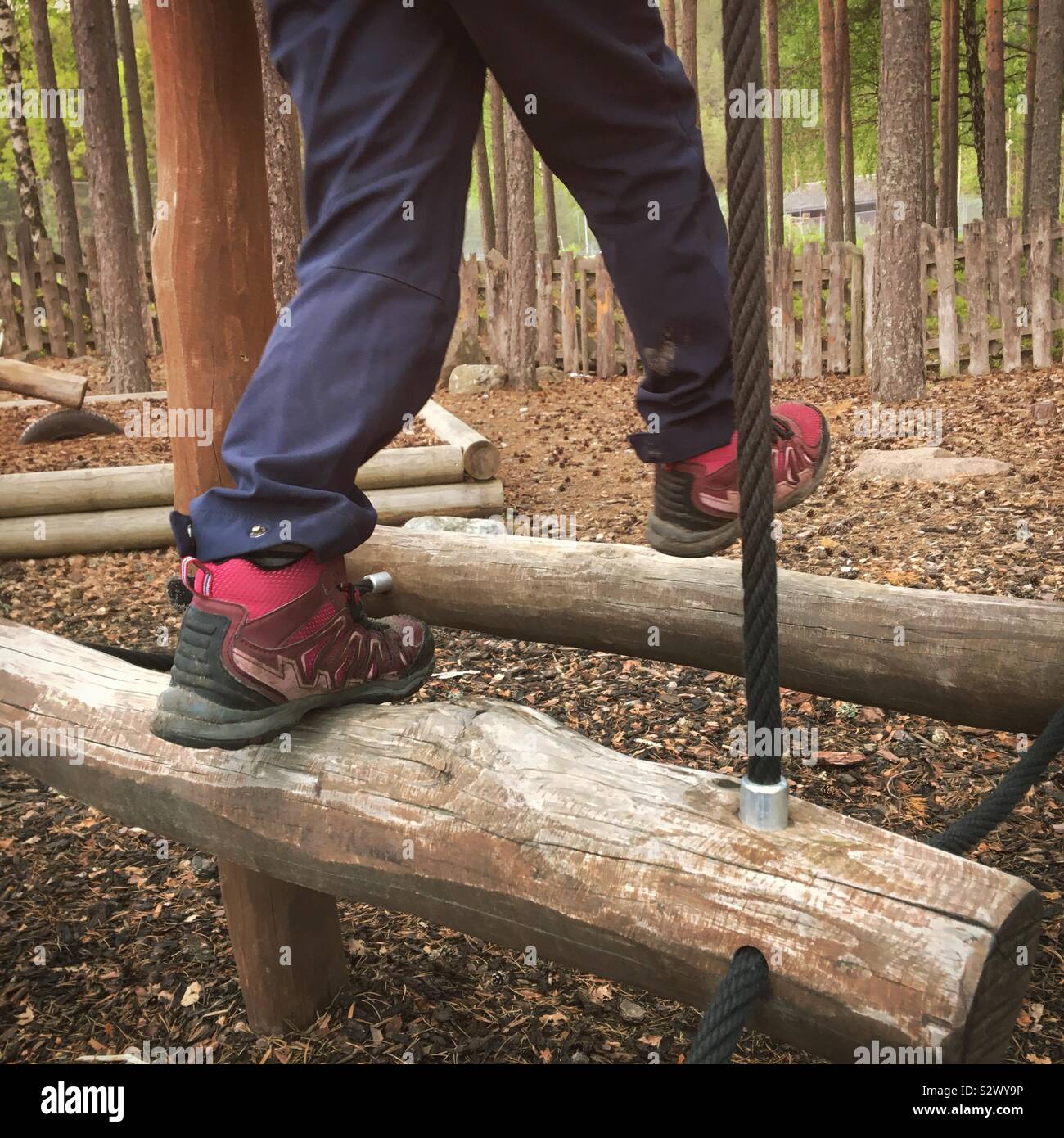 Girl balancing on floating logs Stock Photo - Alamy