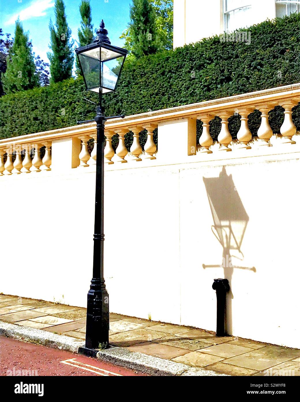 A traditional London lamppost and shadow on a bright summer day Stock ...