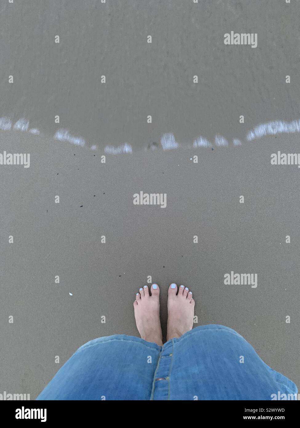 Feet of woman on a shore Stock Photo - Alamy