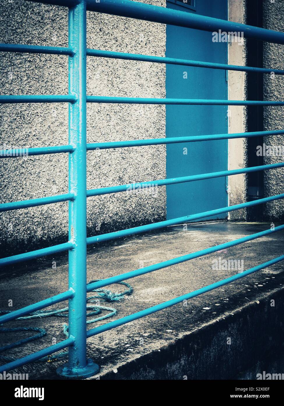 Blue metal railings in front of door of an industrial building Stock ...