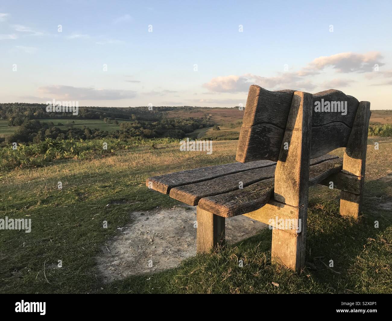 Bench overlooking countryside in evening sun Stock Photo - Alamy