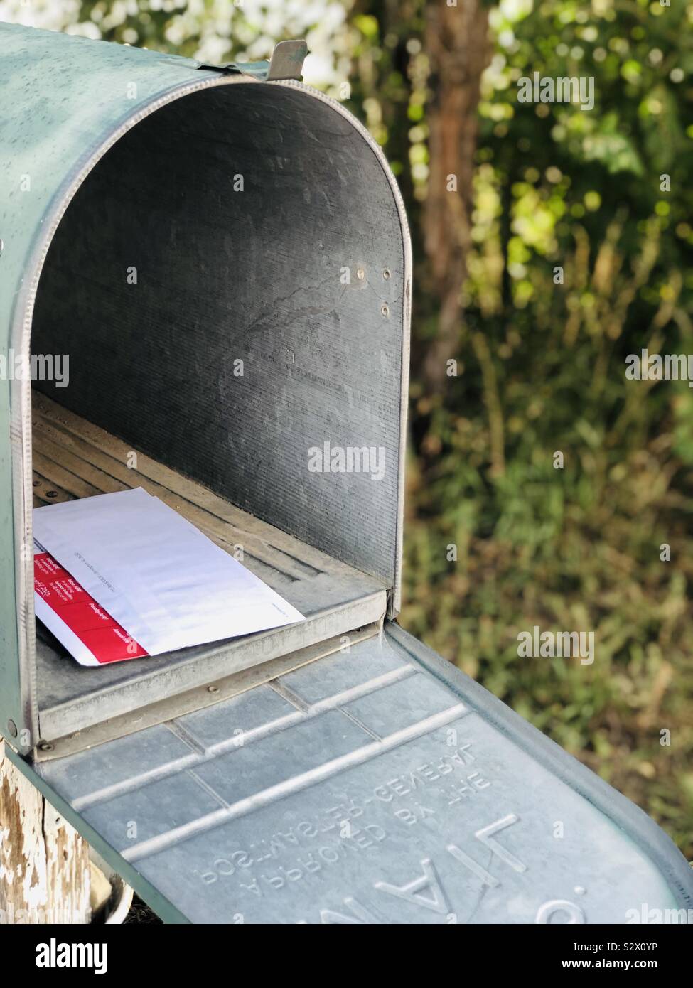 Open mailbox with bills Stock Photo - Alamy