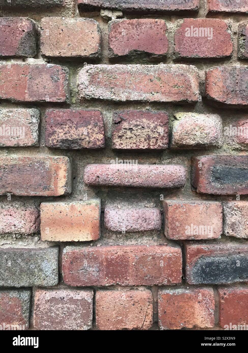 Brick wall given in to the elements Stock Photo - Alamy