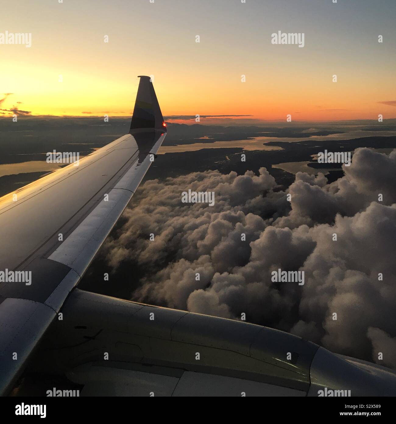 Airplane wing and clouds Stock Photo - Alamy